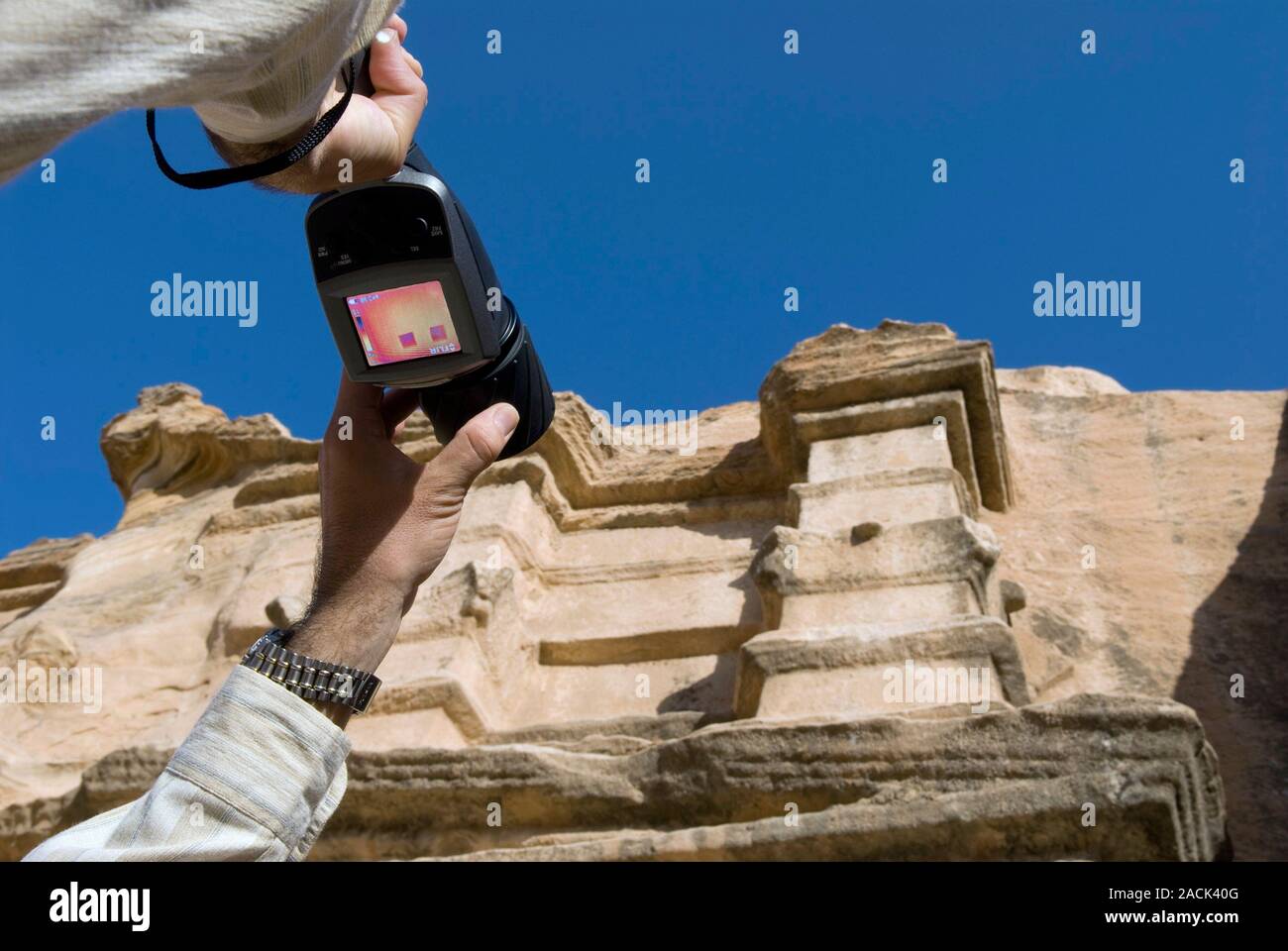 Petra. Archaeologist using a thermal imaging camera to record the ...