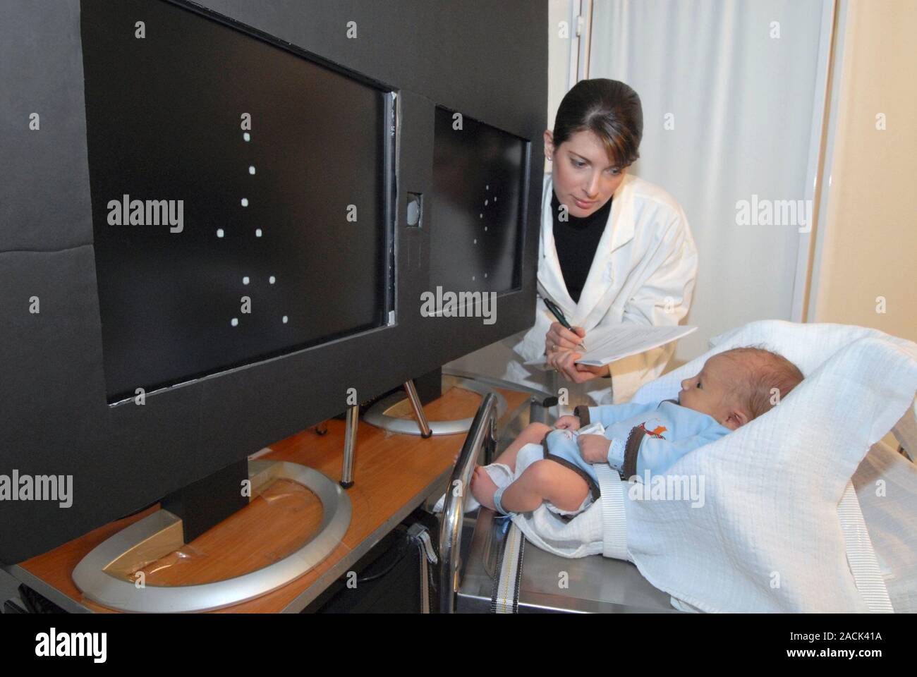 Child development research. Researcher using a device that tracks the ...