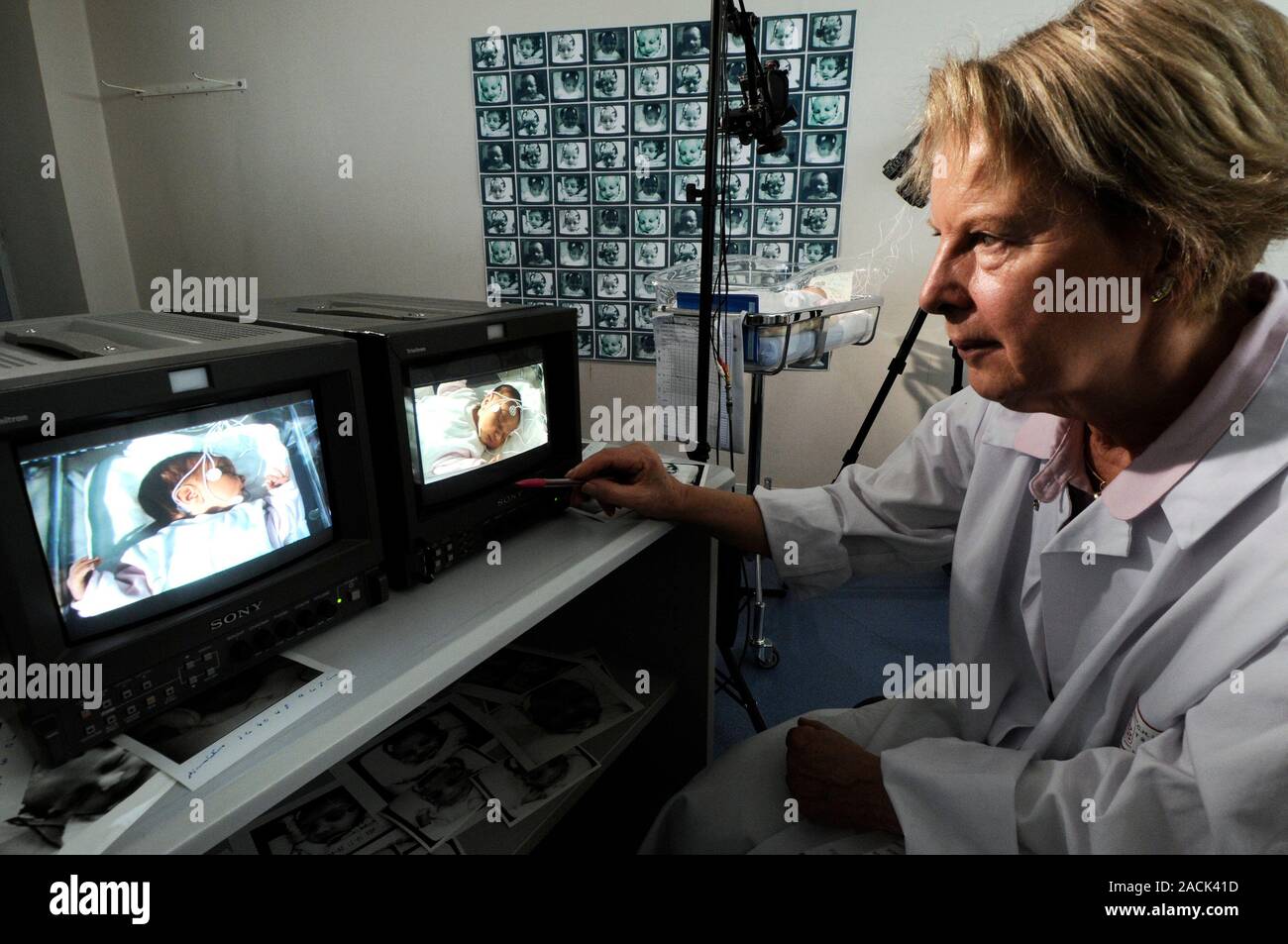 Child development research. Researcher watching recordings of the ...