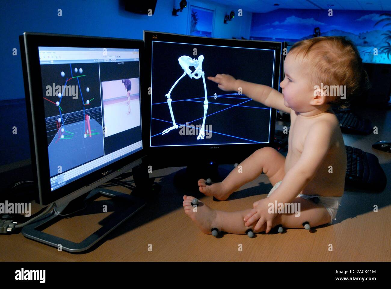 Child development research. Child sat in front of computer screens ...