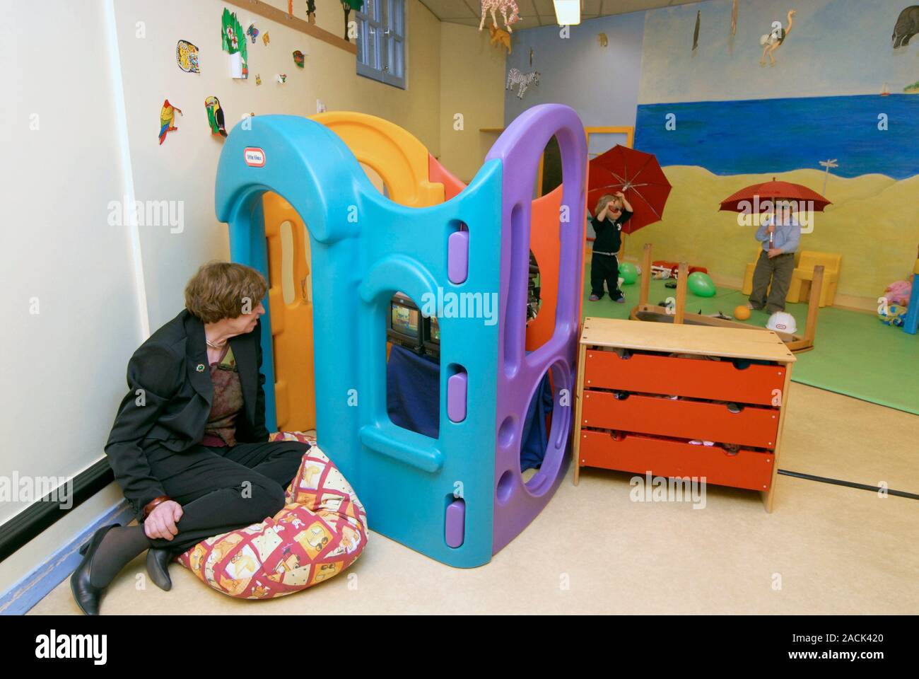 Child development research. Researcher observing two children playing ...
