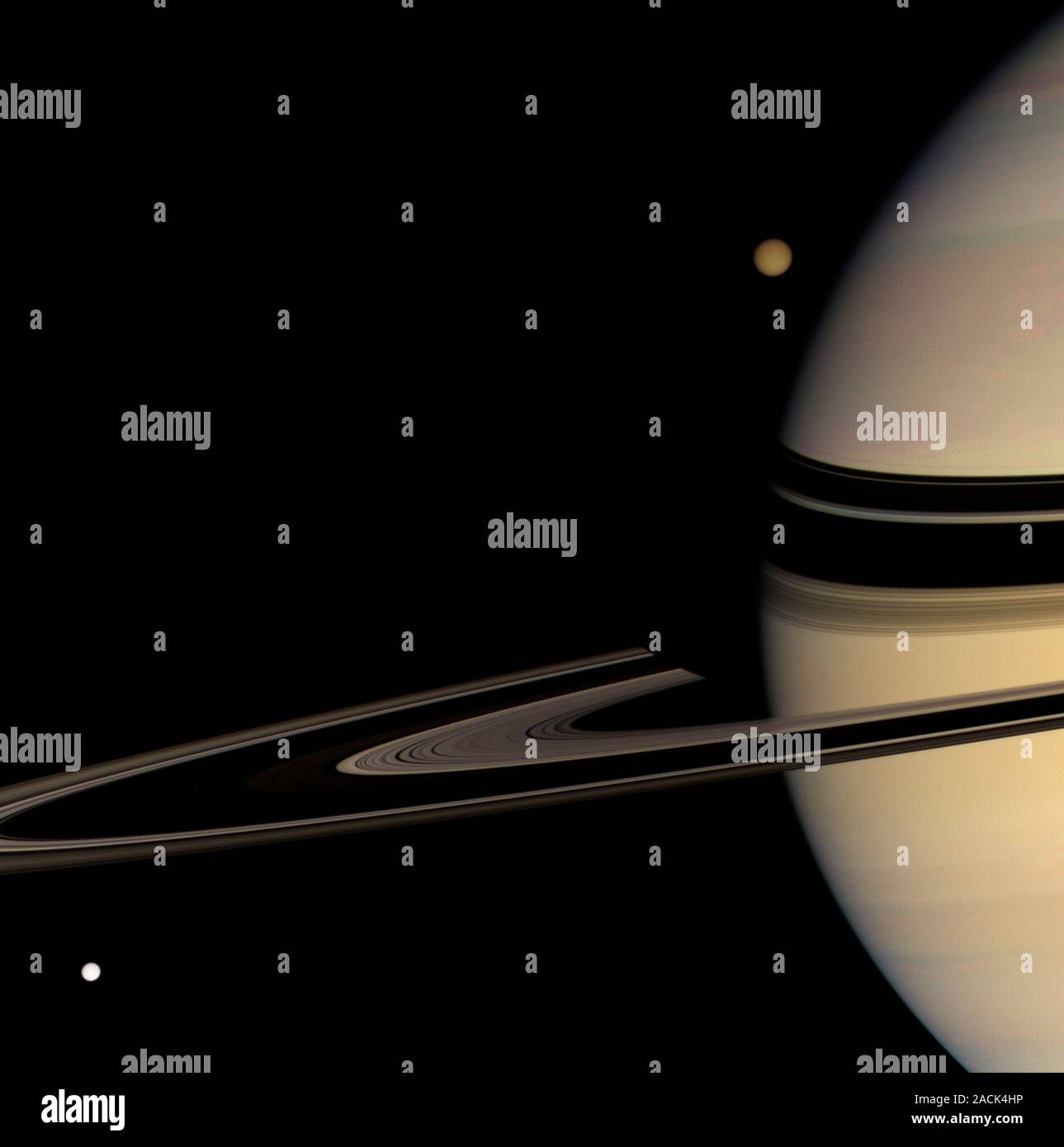 Saturn. Cassini spacecraft image of Saturn, its rings, and two of its ...