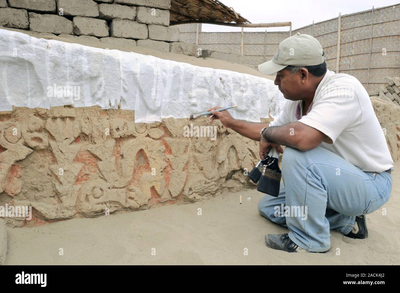 Ancient Peruvian carvings. Archaeologist uncovering bas-relief carvings ...