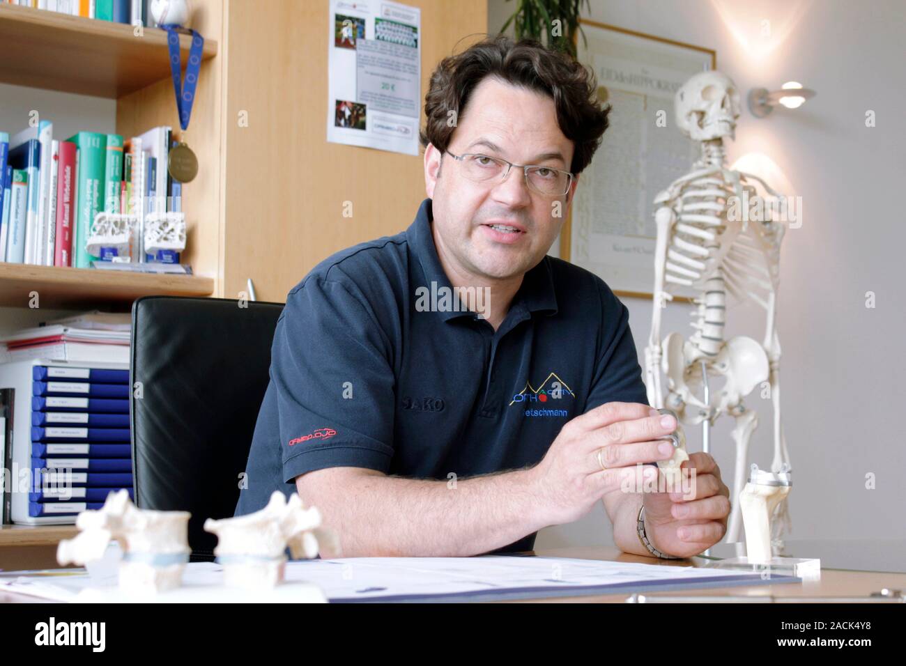 Orthopaedic surgeon sat at a desk in his office Stock Photo - Alamy