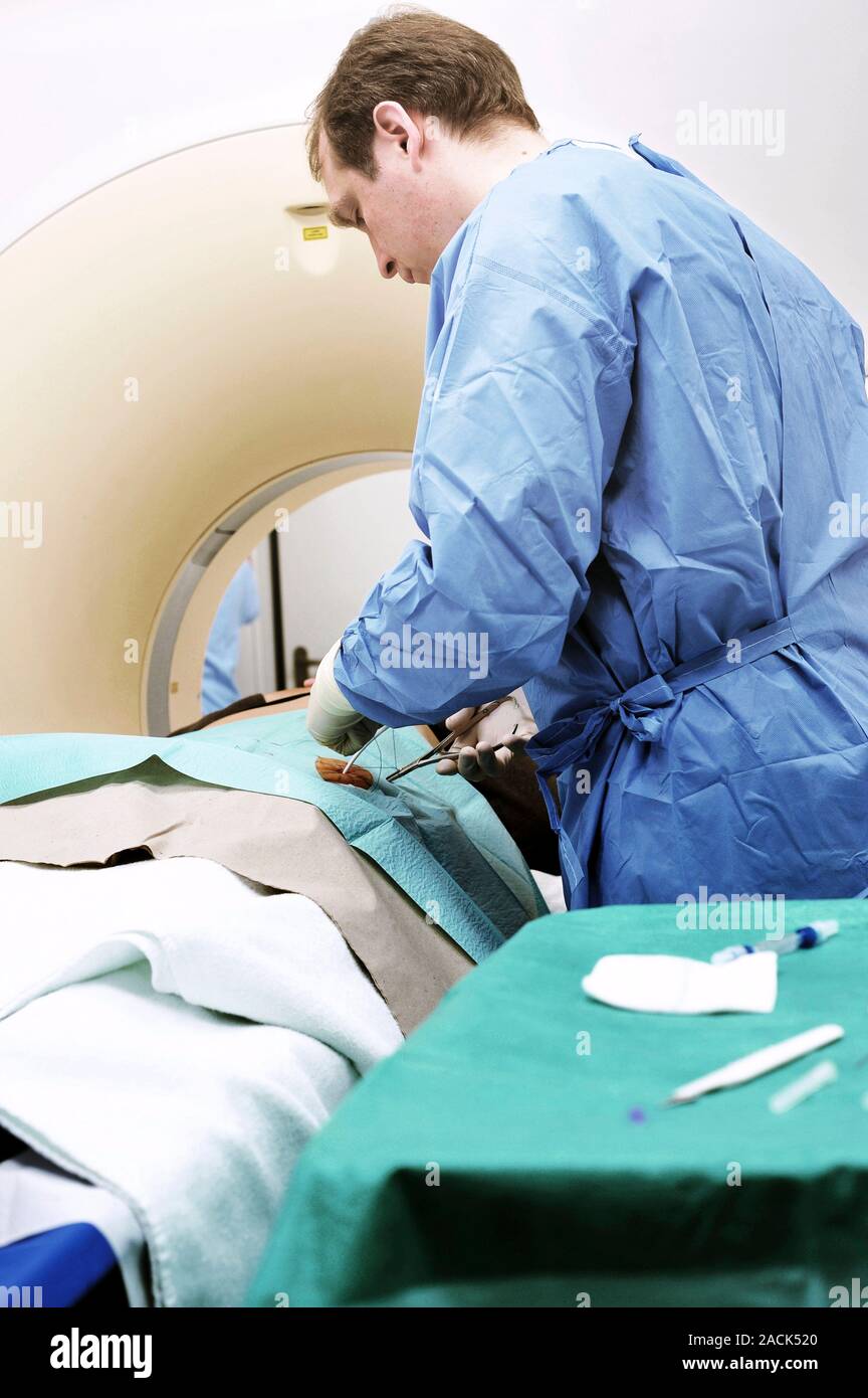 CT scan. Radiologist preparing a patient for a computed tomography (CT ...