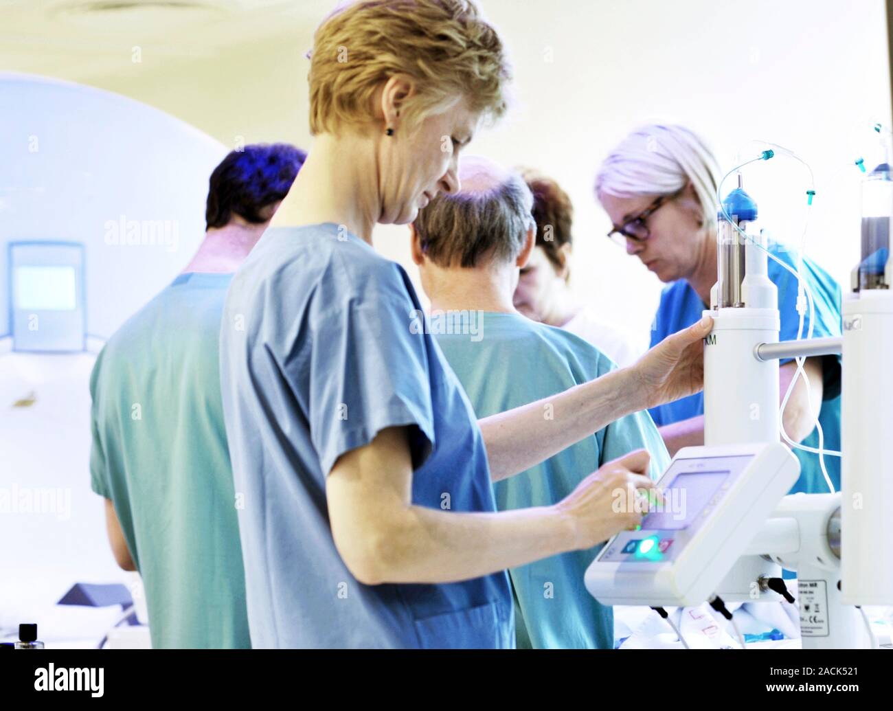 CT scan. Radiologists preparing a patient for a computed tomography (CT ...