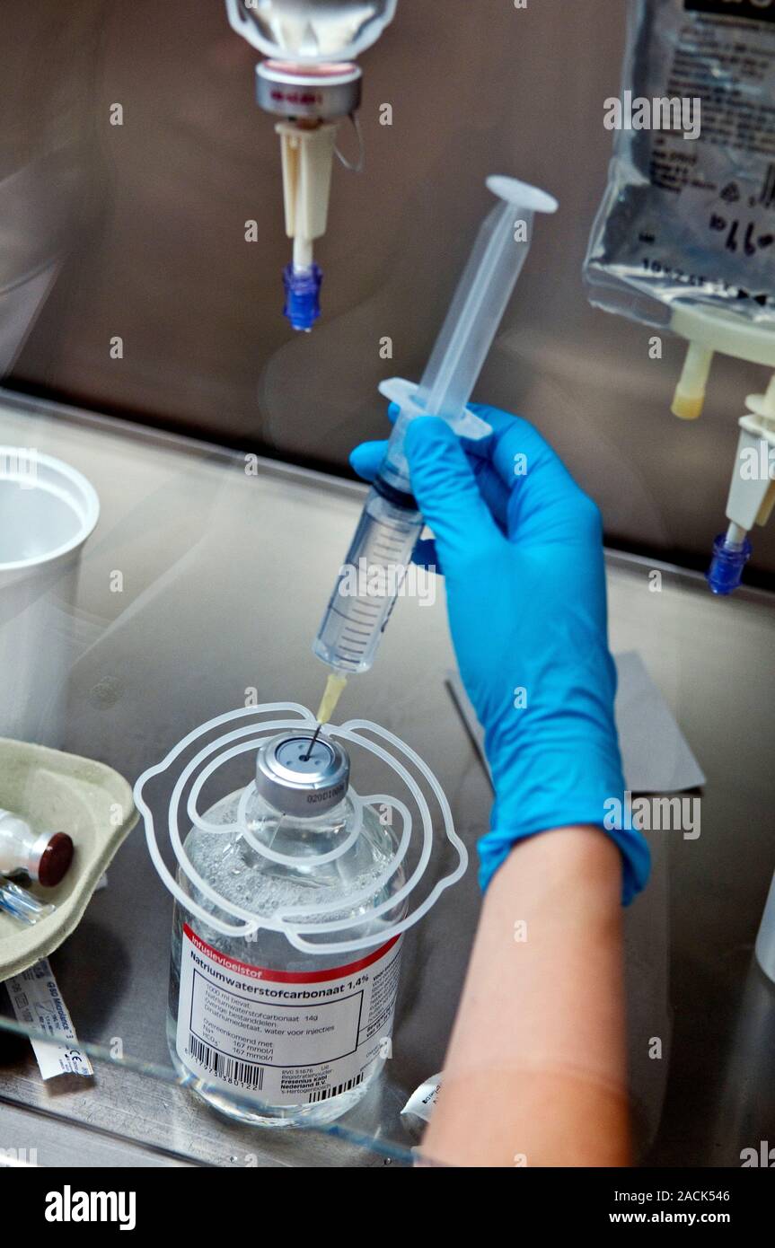 Infusion preparation. Nurse preparing a drug to be administered ...