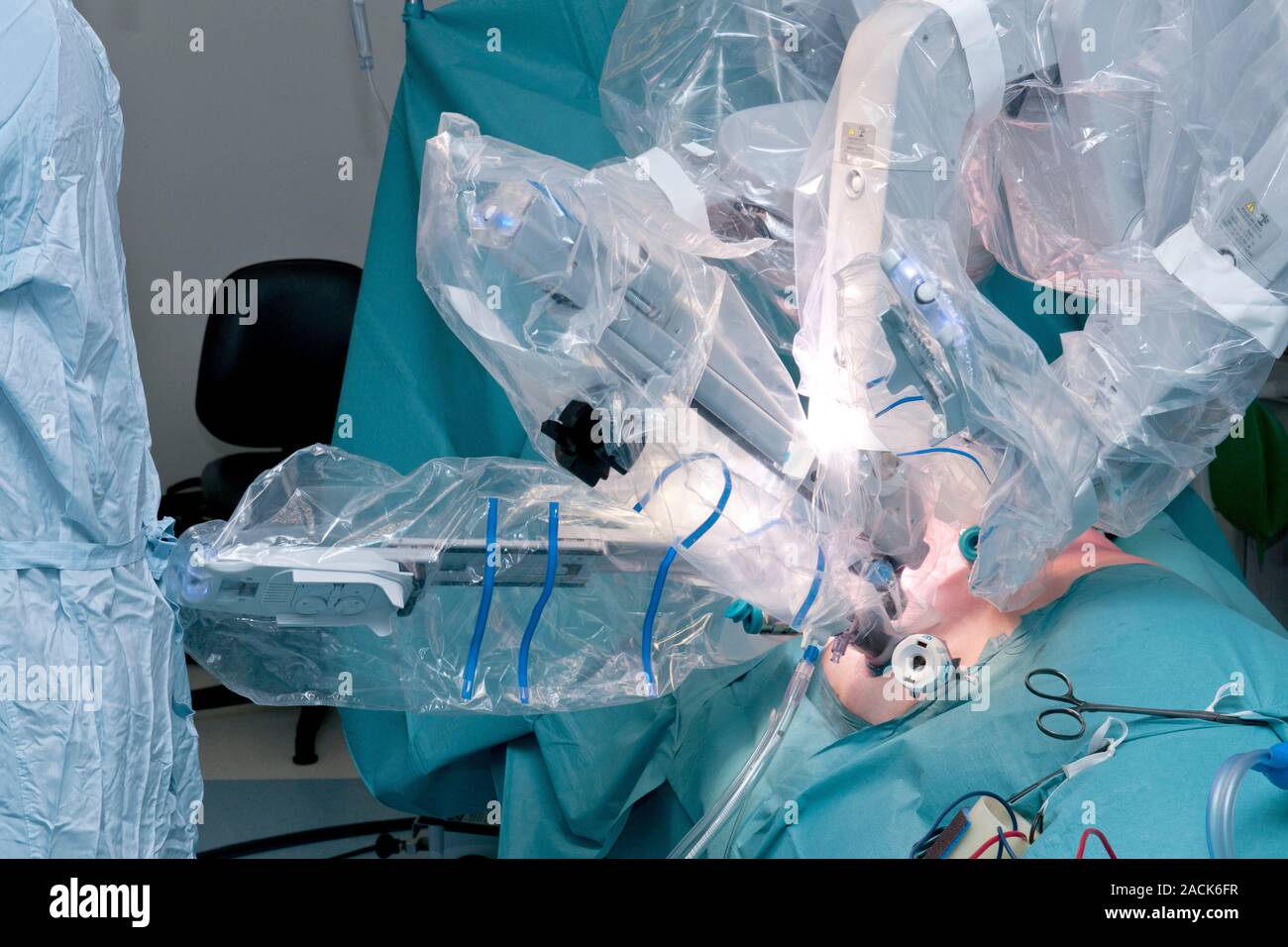 Robotic surgery. Da Vinci robot surgeon operating on a patient. This ...