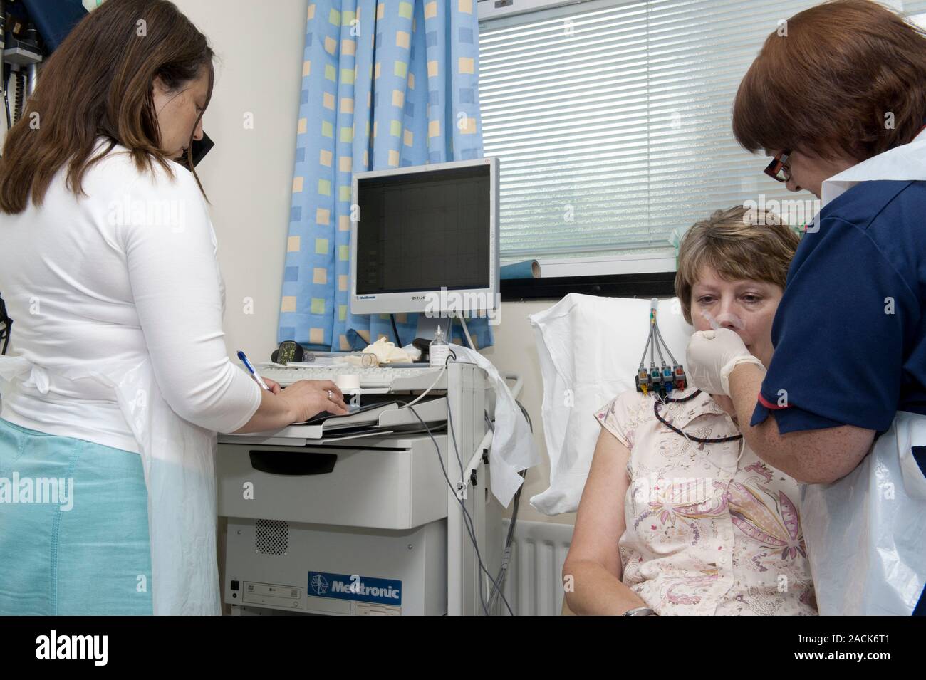 Oesophageal manometry and pH testing. Doctor and nurse fitting a ...