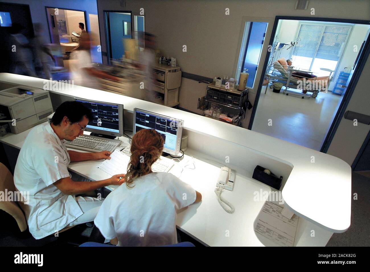 Cardiology department. Nurses and a patient on the cardiology ward of a ...