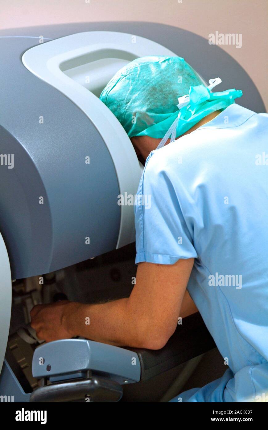 Robotic surgery. Surgeon operating on a patient from the control ...