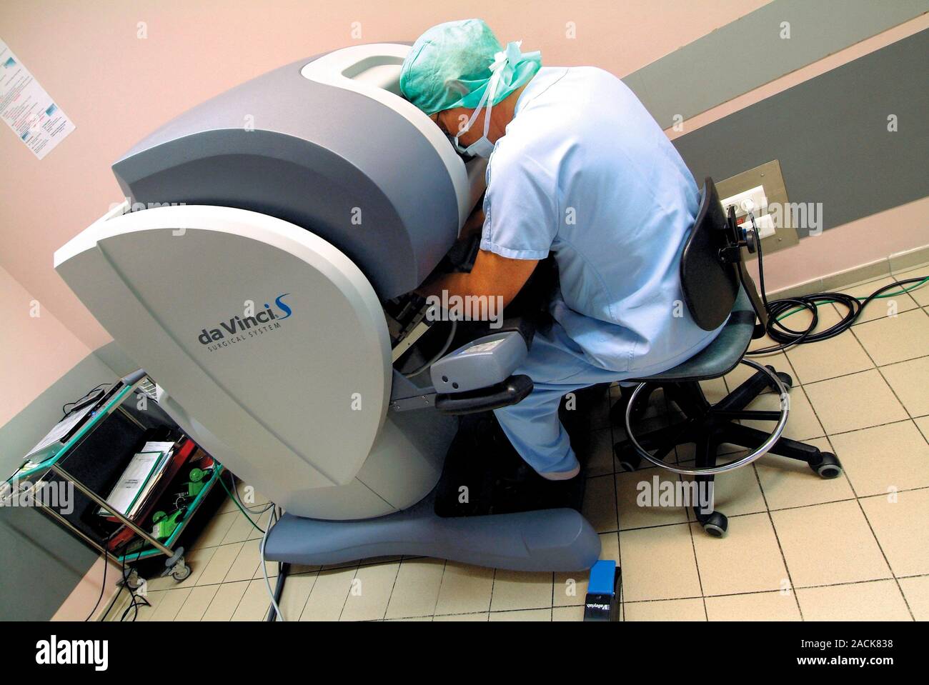 Robotic surgery. Surgeon operating on a patient from the control ...