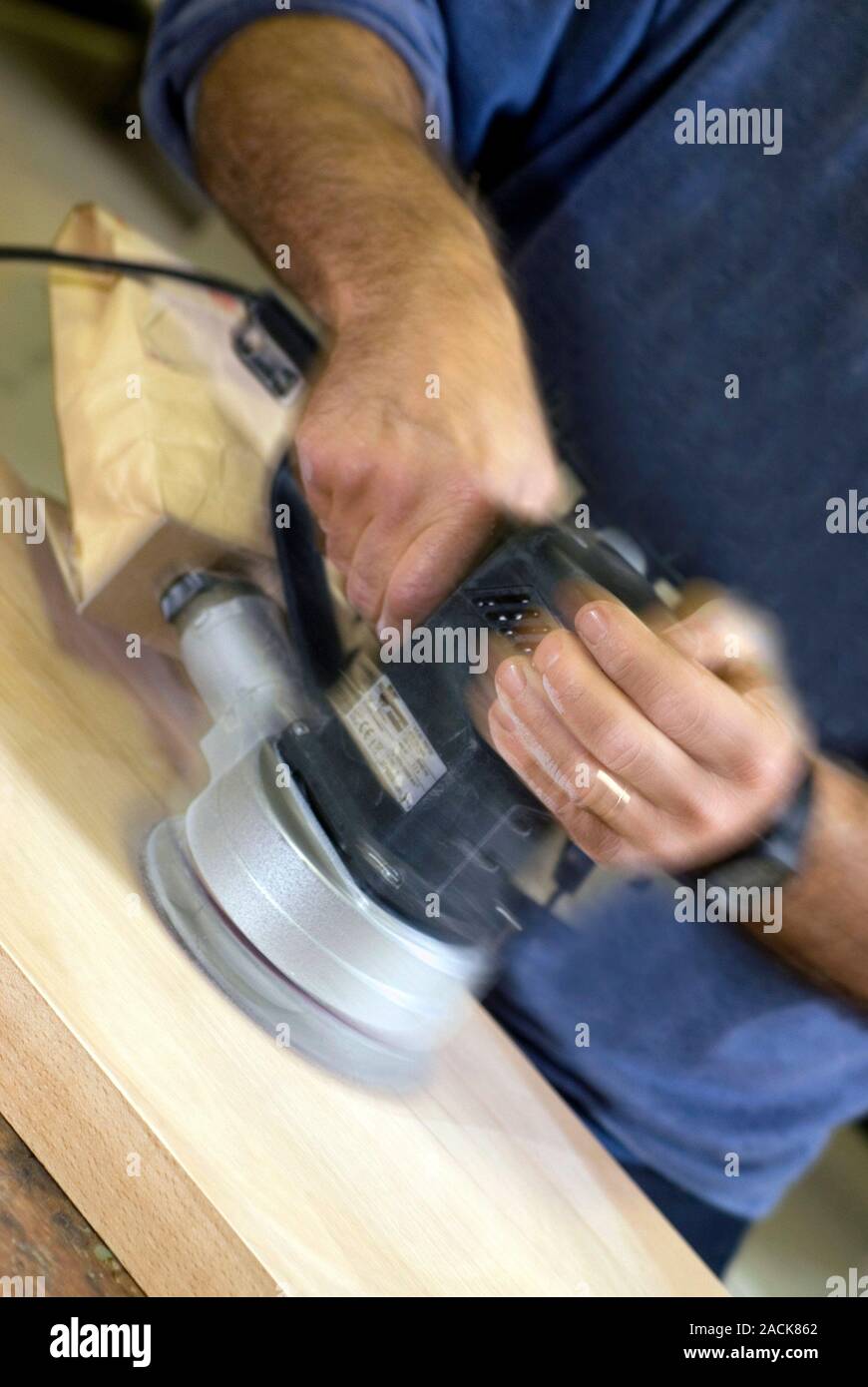 Electric sander being used on a plank of wood Stock Photo - Alamy