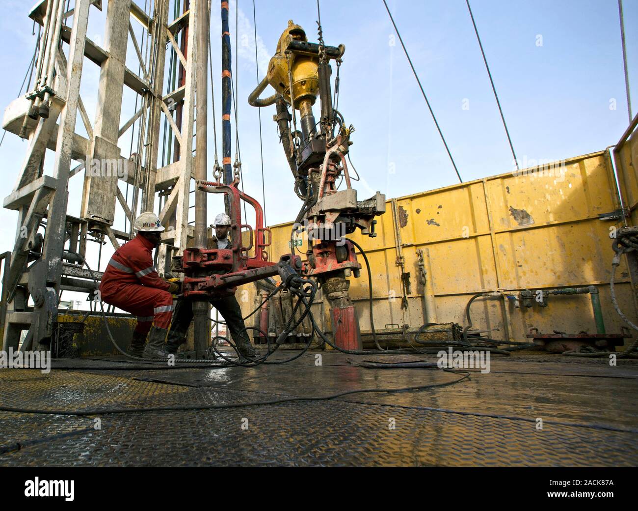 Geothermal well construction. Worker drilling a new well at the site of ...