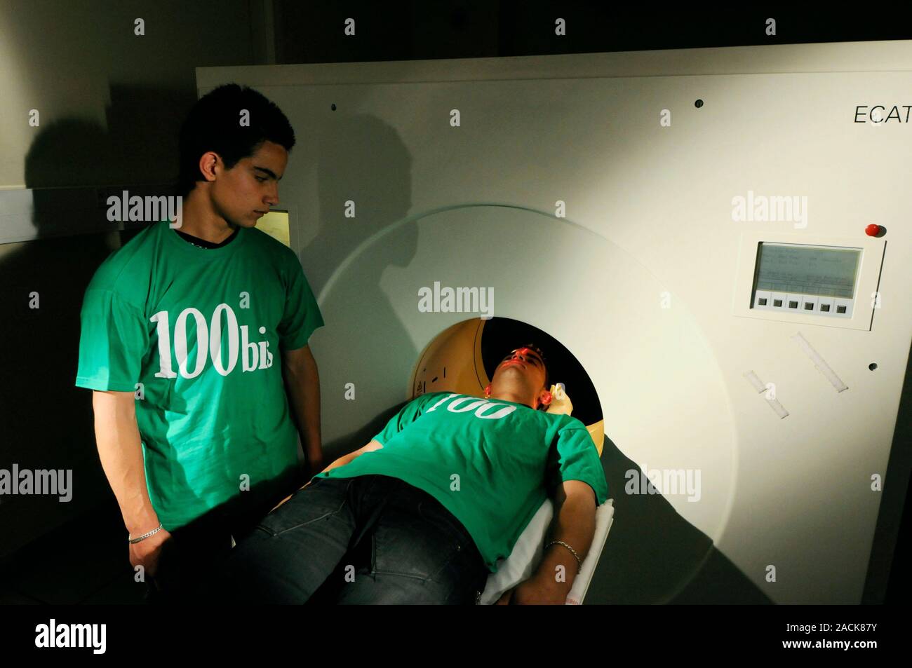 Twin research. Teenage twins undergoing an MRI scan of their brains ...