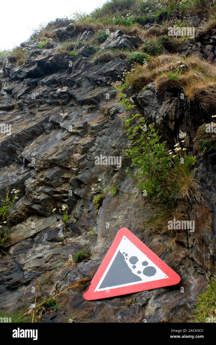 Falling rocks warning sign on cliffs in Pentre, near Pontgarreg, Wales ...