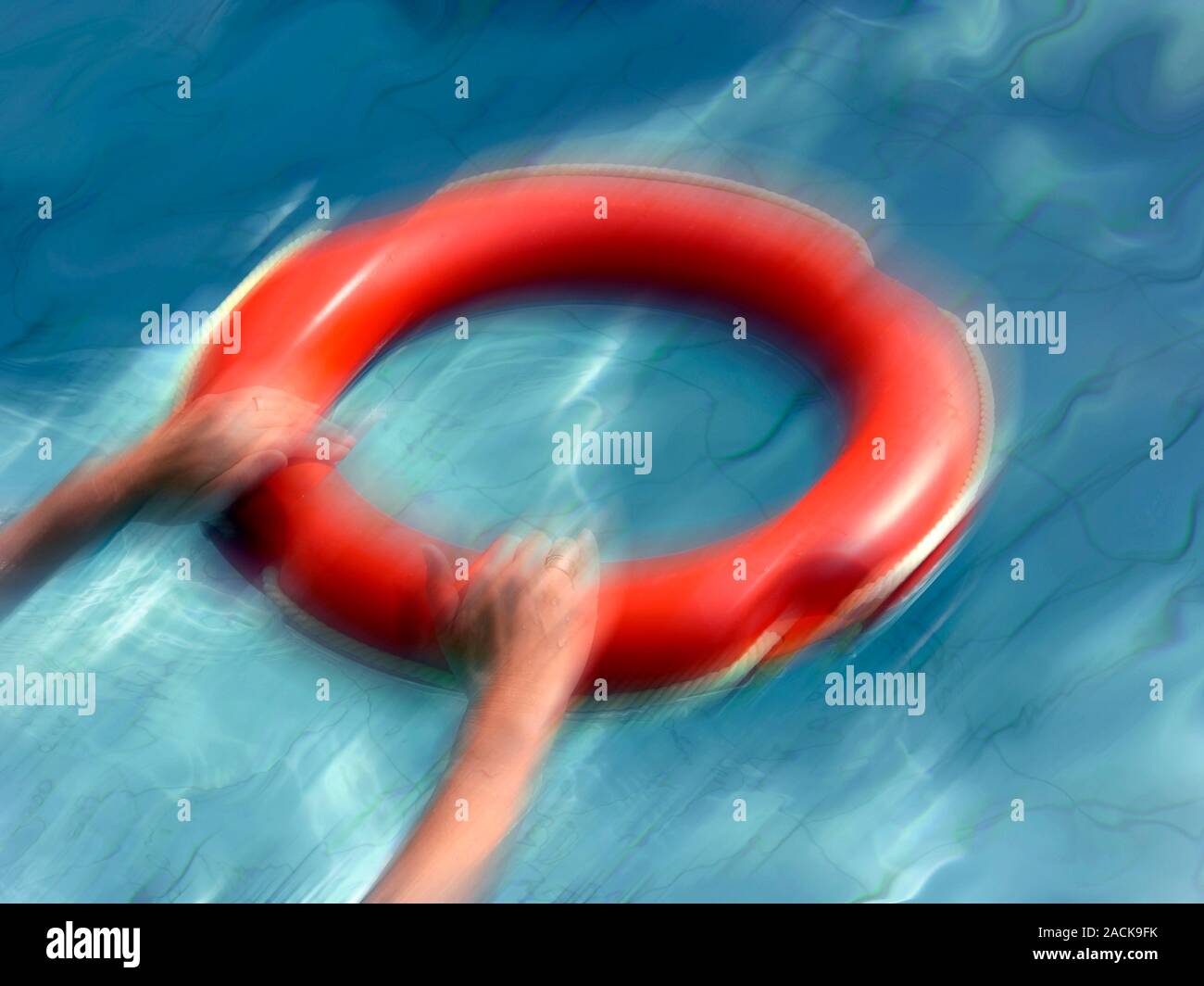 Lifebuoy in a swimming pool. Ring-shaped lifebuoy being used in a ...