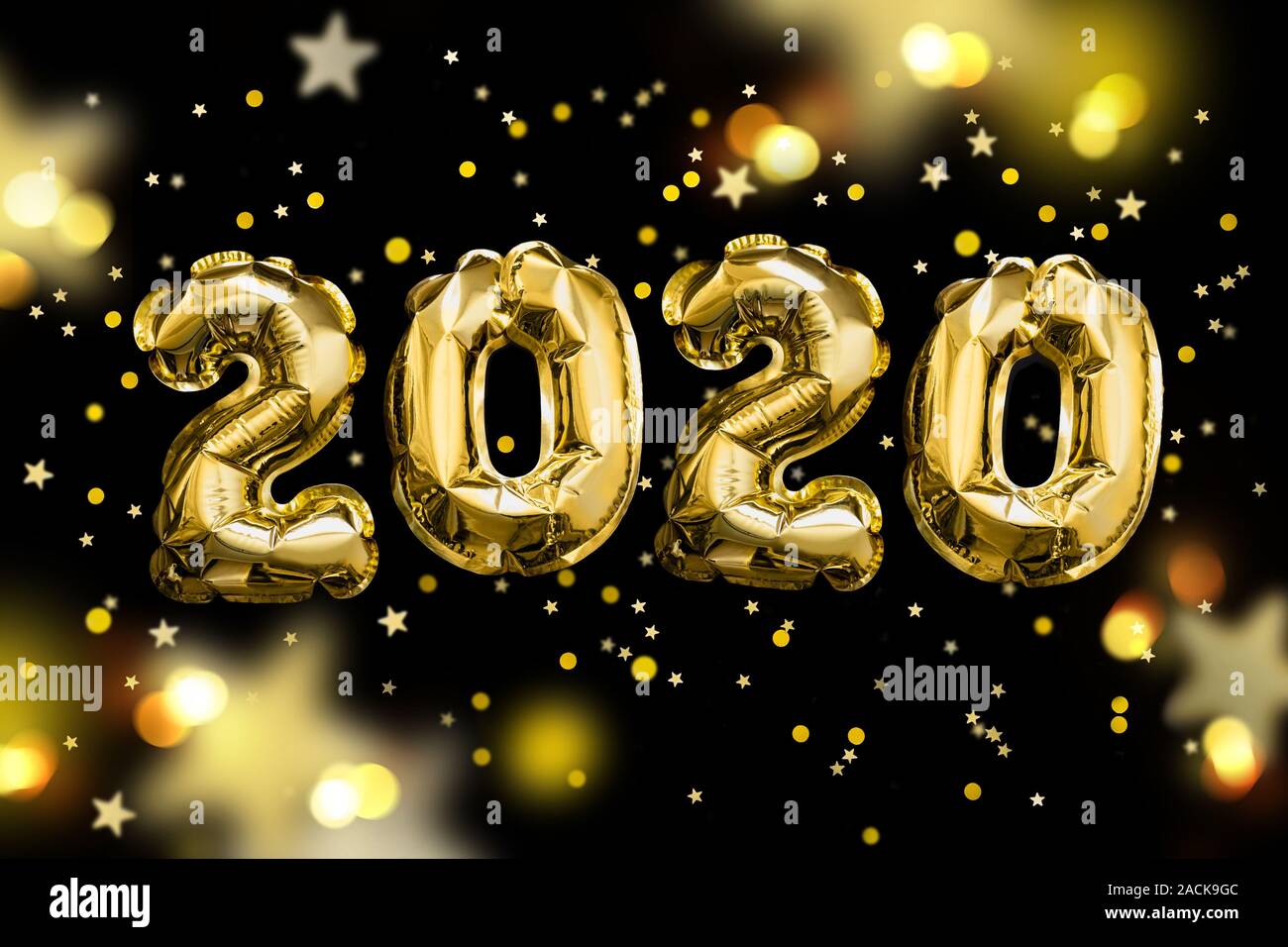 Soaring Numbers 2020 made from foil balloons and shining stars on black ...