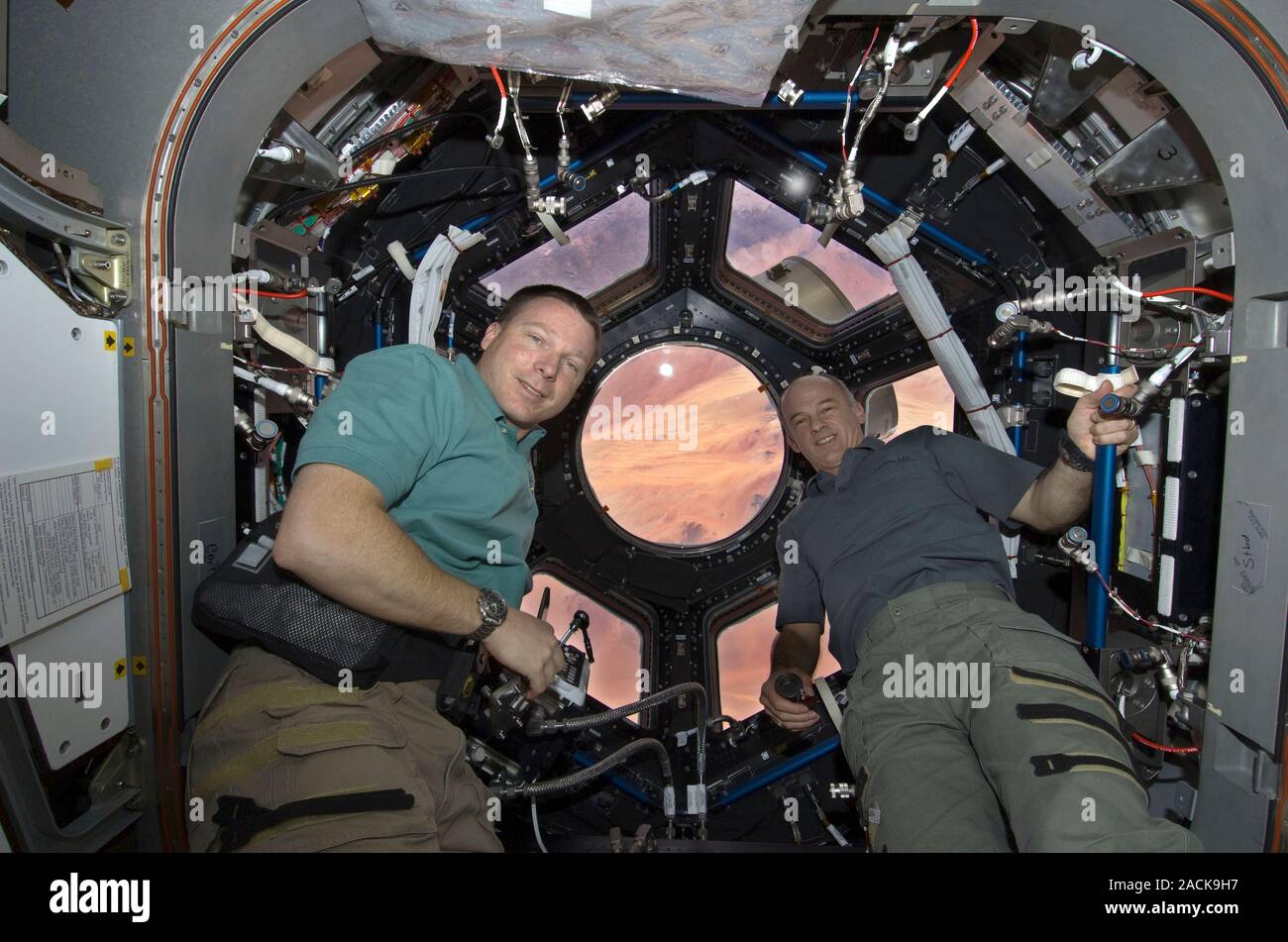NASA astronauts on the ISS. STS-130 mission pilot Terry Virts (left ...