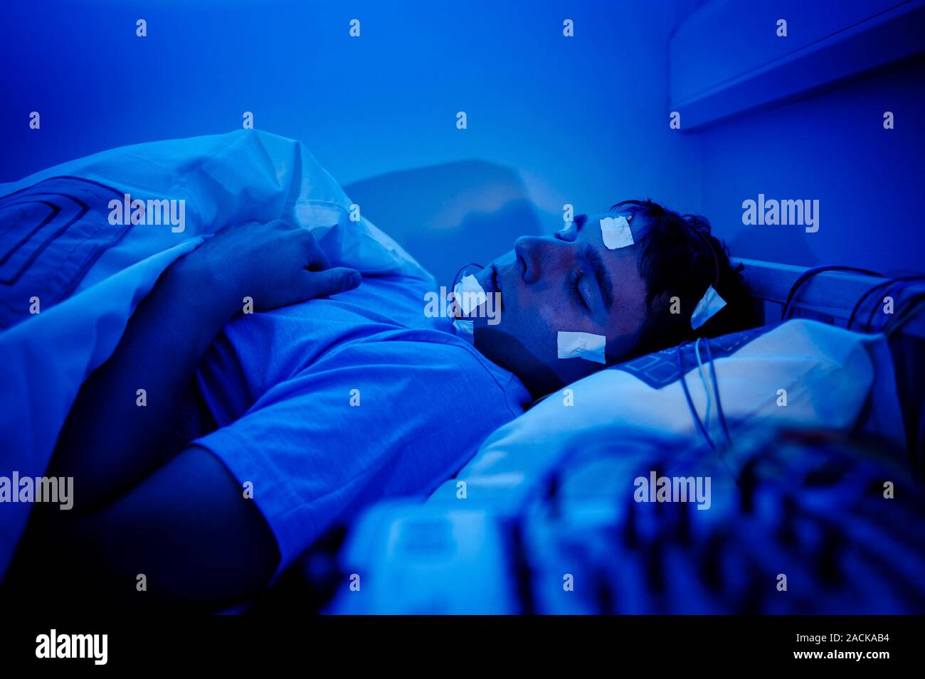 Sleep research. Patient attached to an electroencephalogram (EEG ...