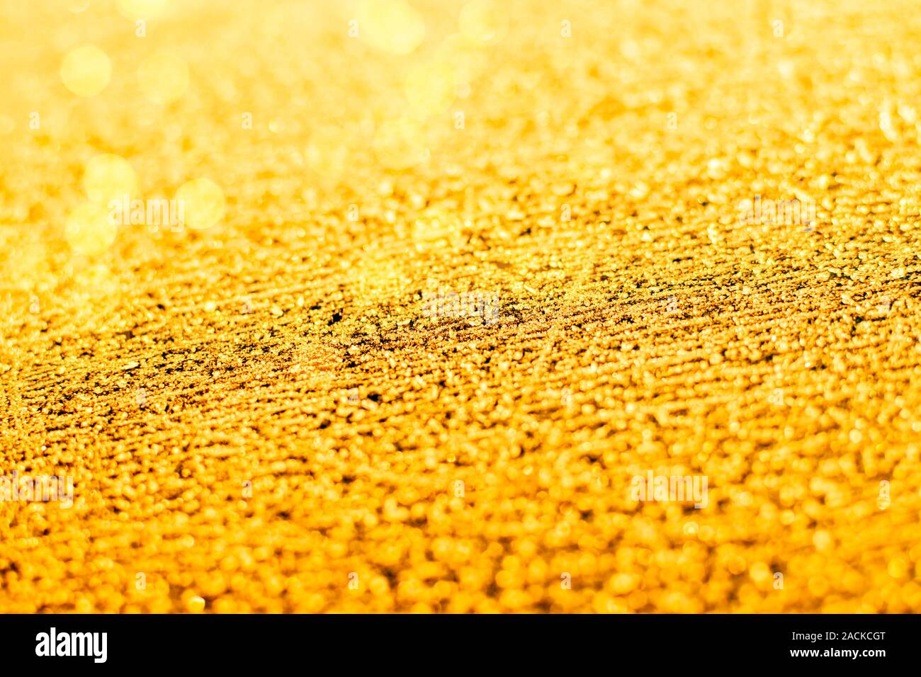 Texture of sparkling first cold ice. Snowy backdrop in gold color ...