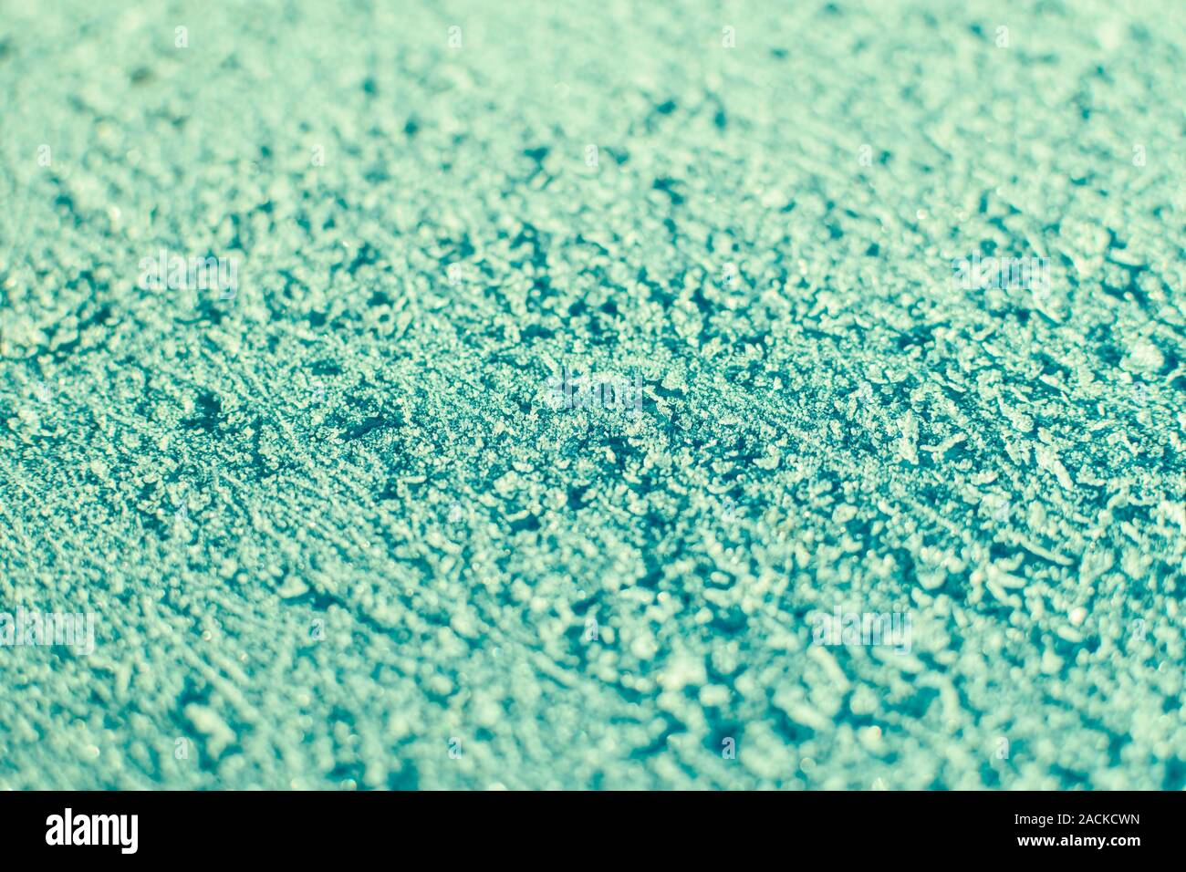 Texture of sparkling first cold ice. Snowy backdrop in green colors ...