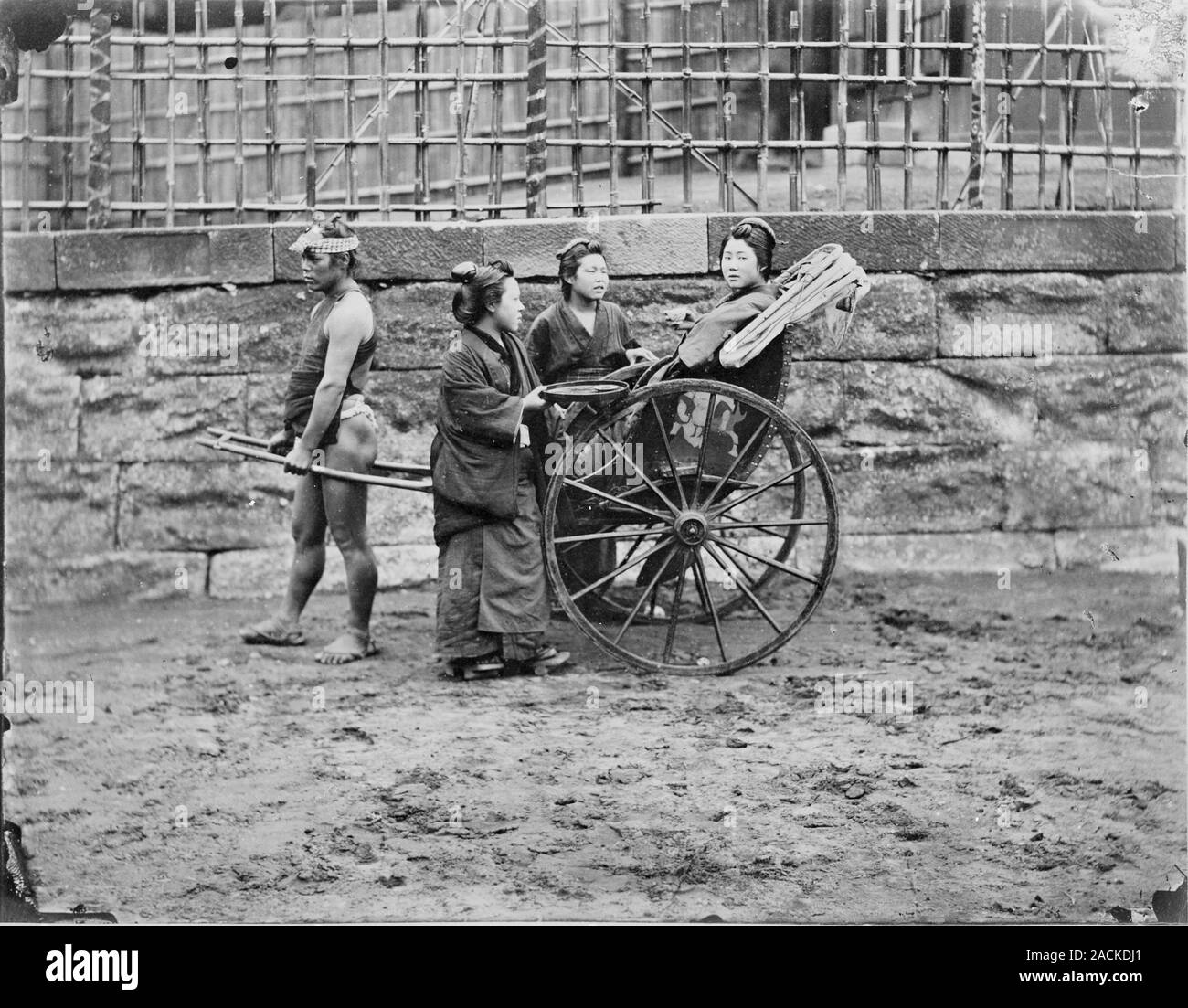 Japanese rickshaw. Women beside a jinrikisha (Japanese rickshaw) in ...