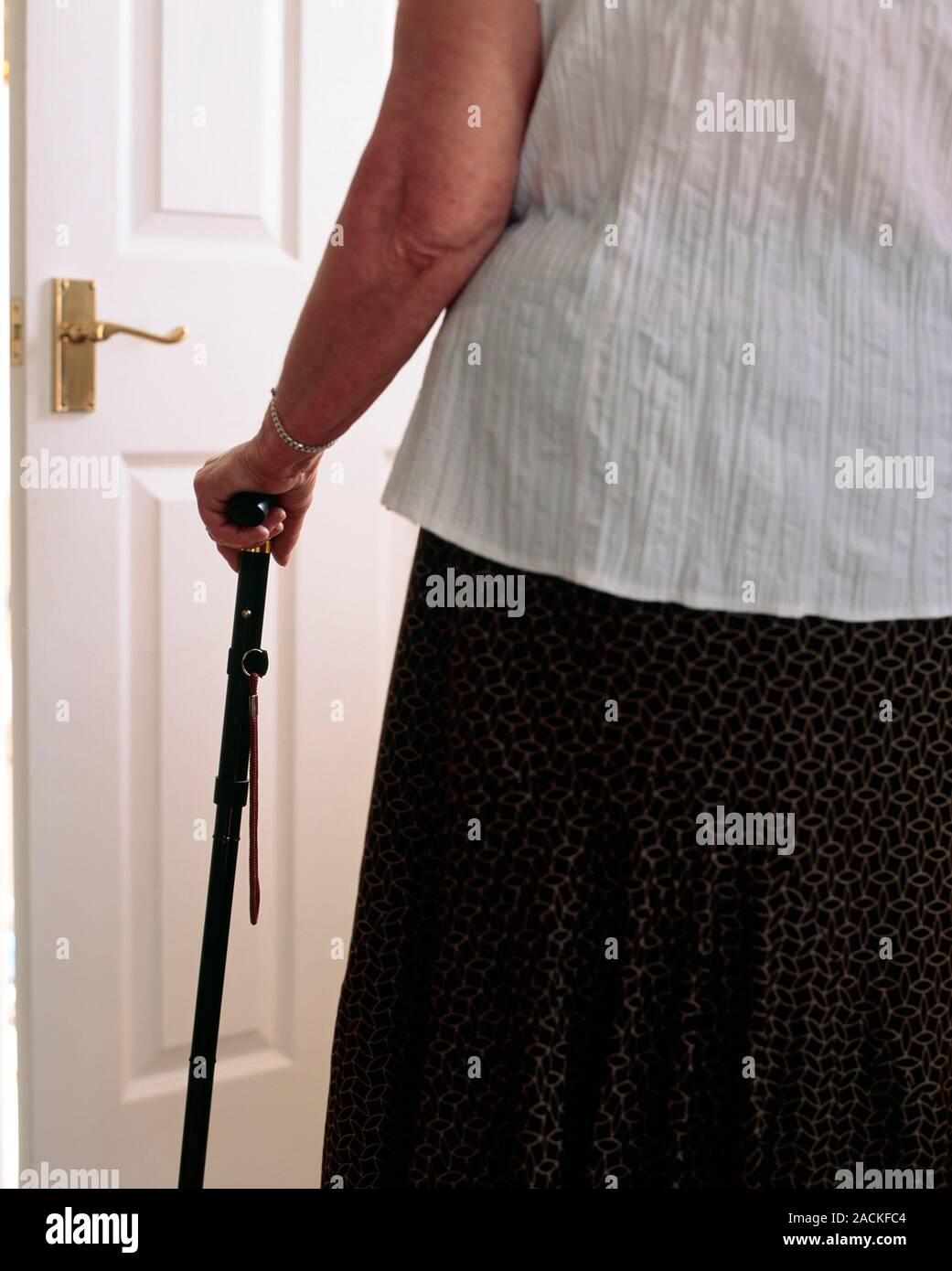 Using a walking stick. Elderly woman using a walking stick Stock Photo ...