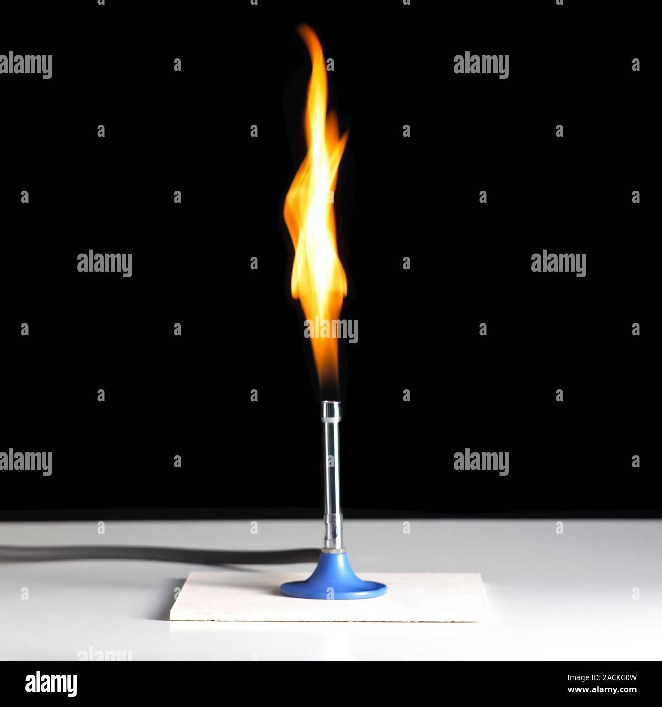 Bunsen burner flame. This device burns hydrocarbon gases (supplied ...