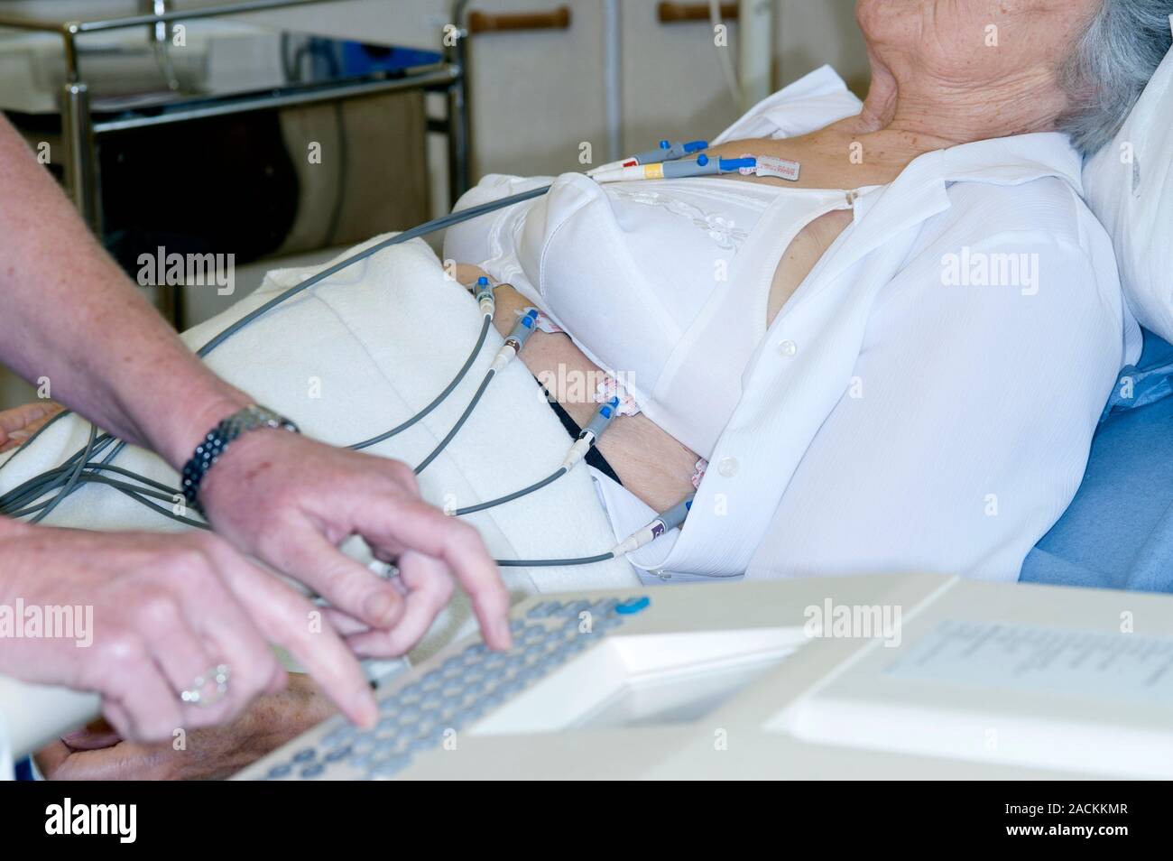 Electrodes attached to the skin of the chest in an elderly female ...