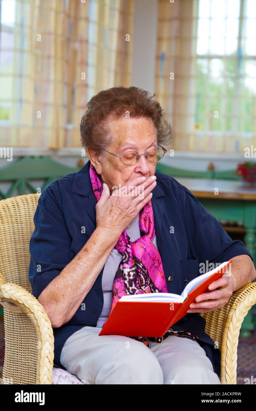 Seniors sitting in an armchair Stock Photo - Alamy