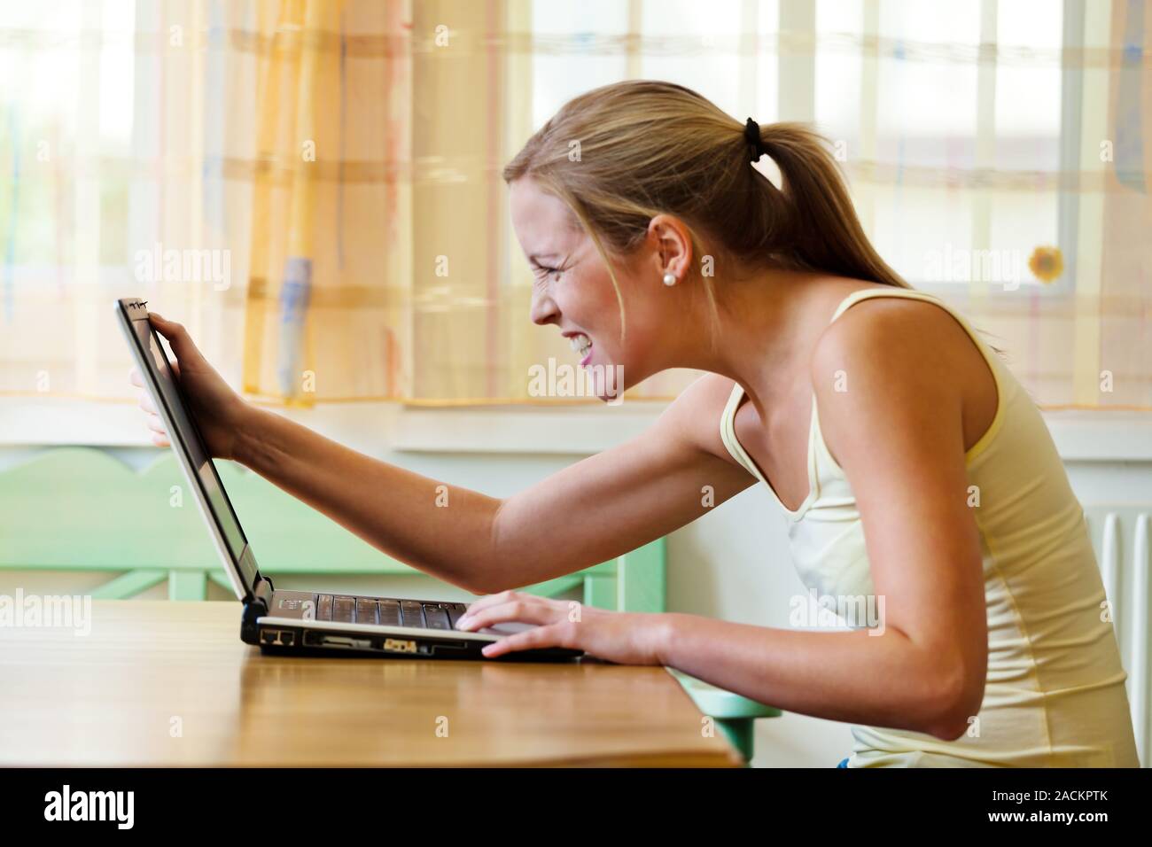 Woman gets angry about computer Stock Photo - Alamy