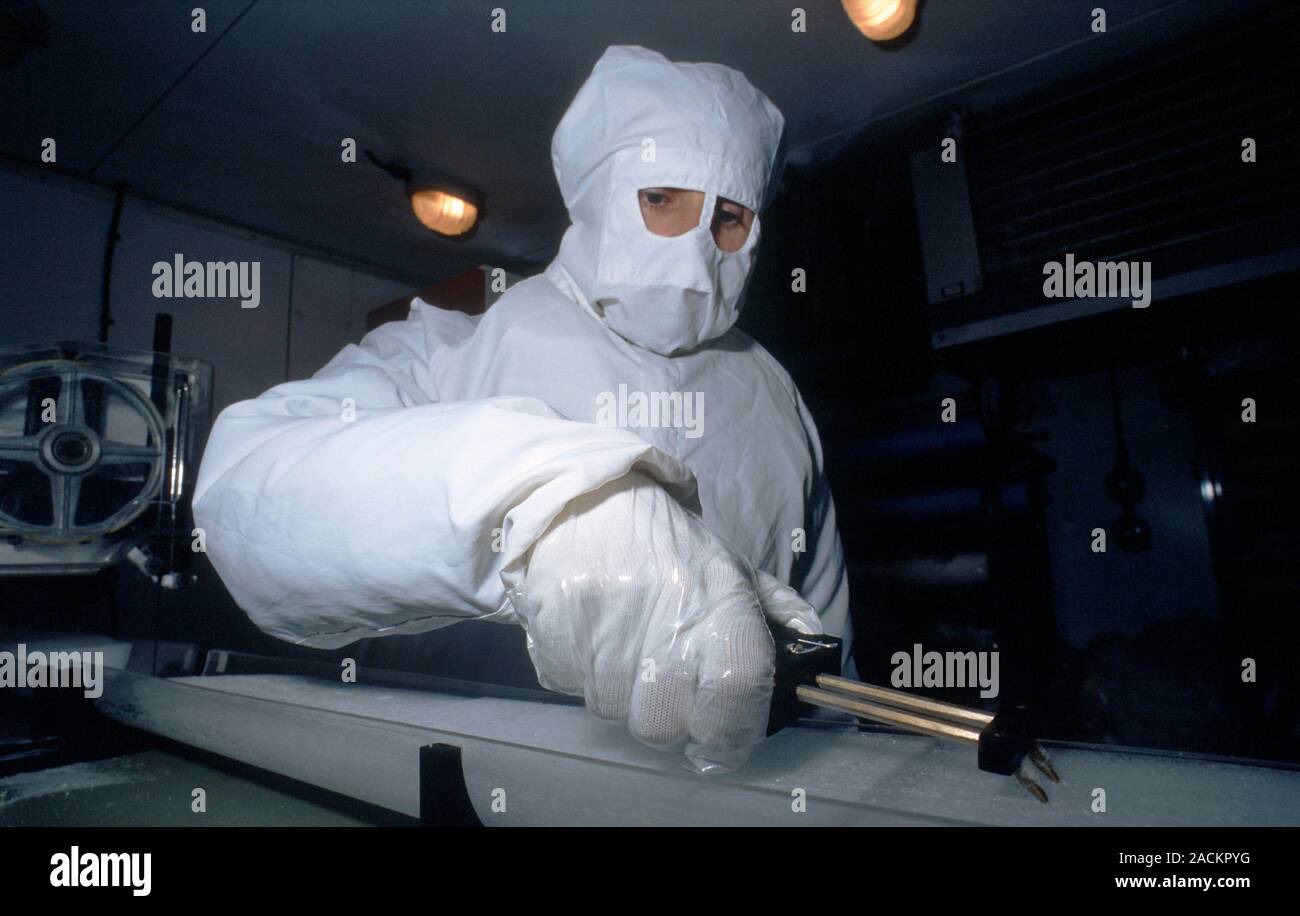 Antarctic ice core research. Researcher taking measurements from an ice ...