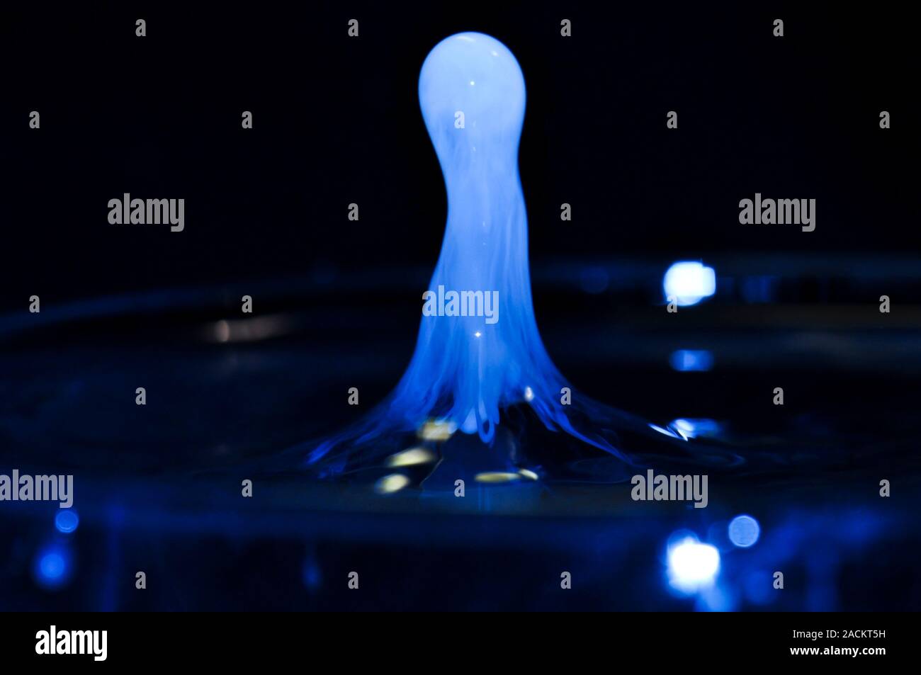 High-speed flash photograph liquid column created by the impact of a ...