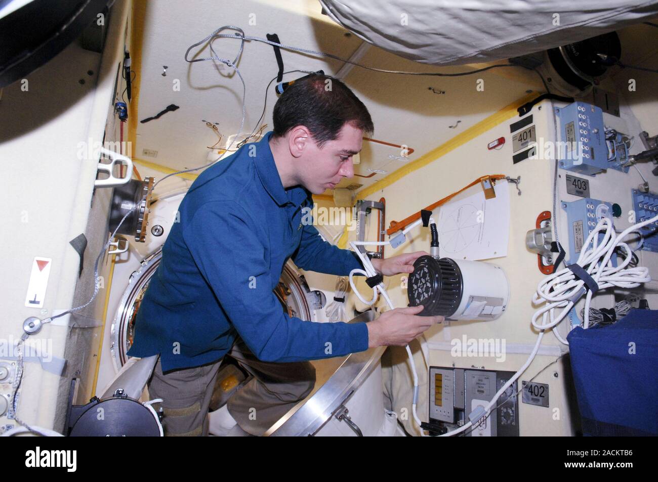 ISS maintenance. Russian cosmonaut Sergei Volkov (born 1973) working in ...