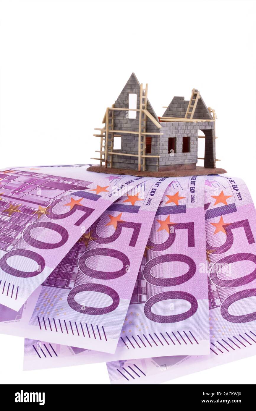 Euro banknotes and building shell of a house Stock Photo - Alamy
