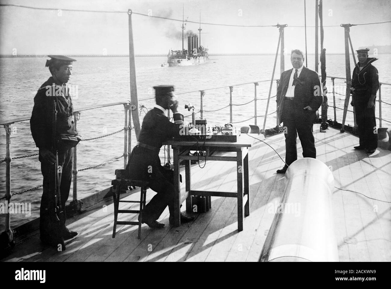 Naval telephone. Officer on the deck of a boat using a Collins naval ...