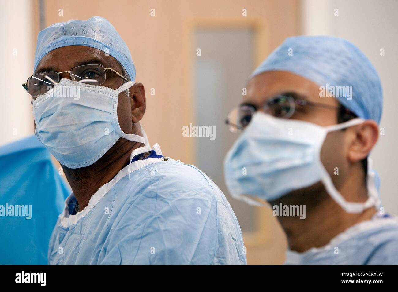 Portrait of two male surgeons dressed in surgical clothing during ...