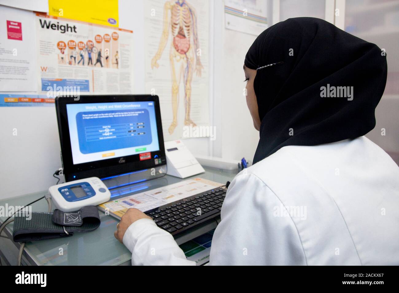 Female General Practice (GP) doctor at a workstation Stock Photo - Alamy
