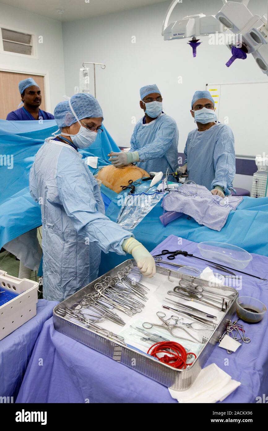 Surgeons using laparoscopes (endoscopes) to repair an incisional hernia ...