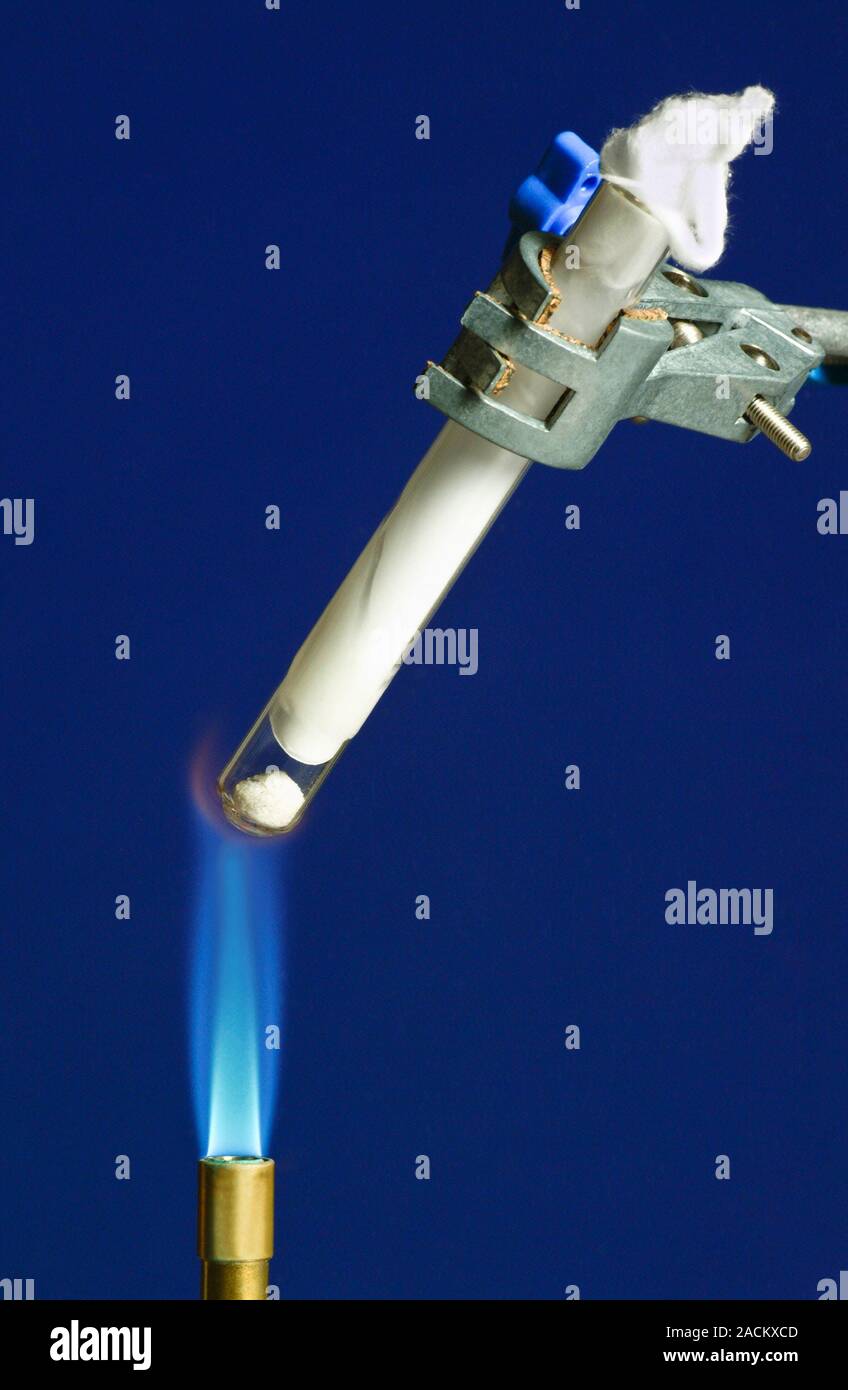 Ammonium chloride decomposition. Test tube of ammonium chloride (NH4Cl ...