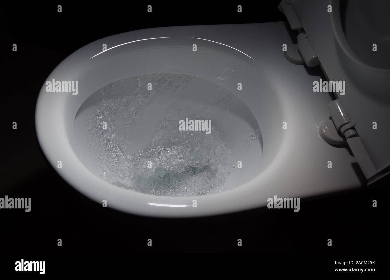 Water flushing in toilet bowl Stock Photo - Alamy