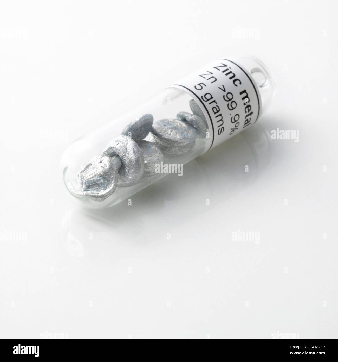 Zinc. Vial containing samples of the metal zinc (Zn). Zinc is a bluish ...
