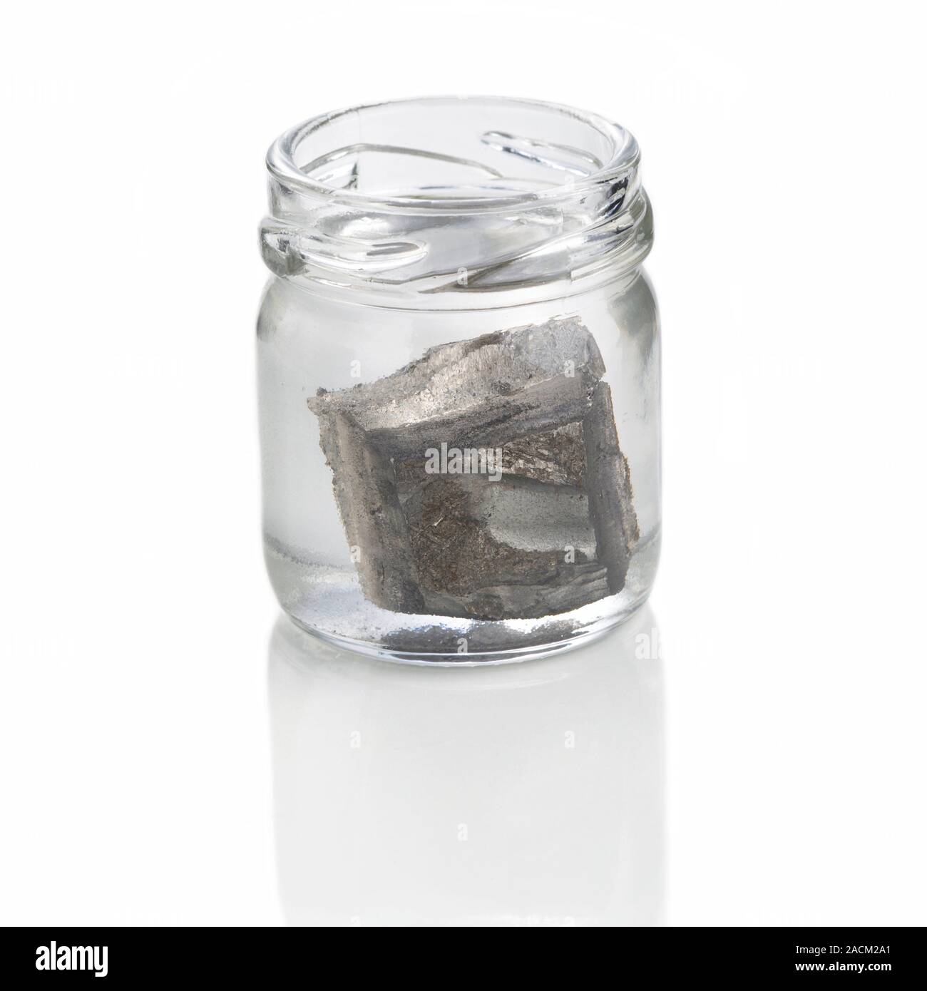 Calcium. Jar containing a sample of the alkaline earth metal calcium ...