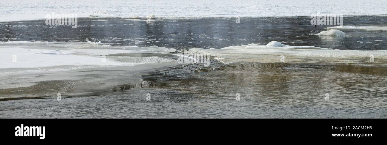 Spring and snow on the river Stock Photo - Alamy