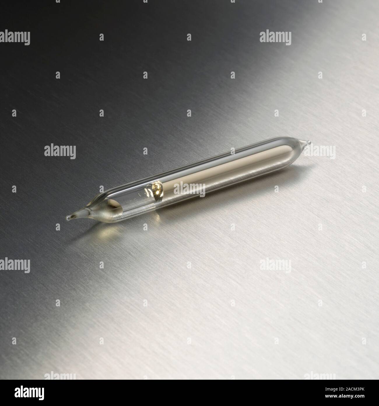 Caesium. Vial containing a sample of the alkali metal caesium (Cs ...