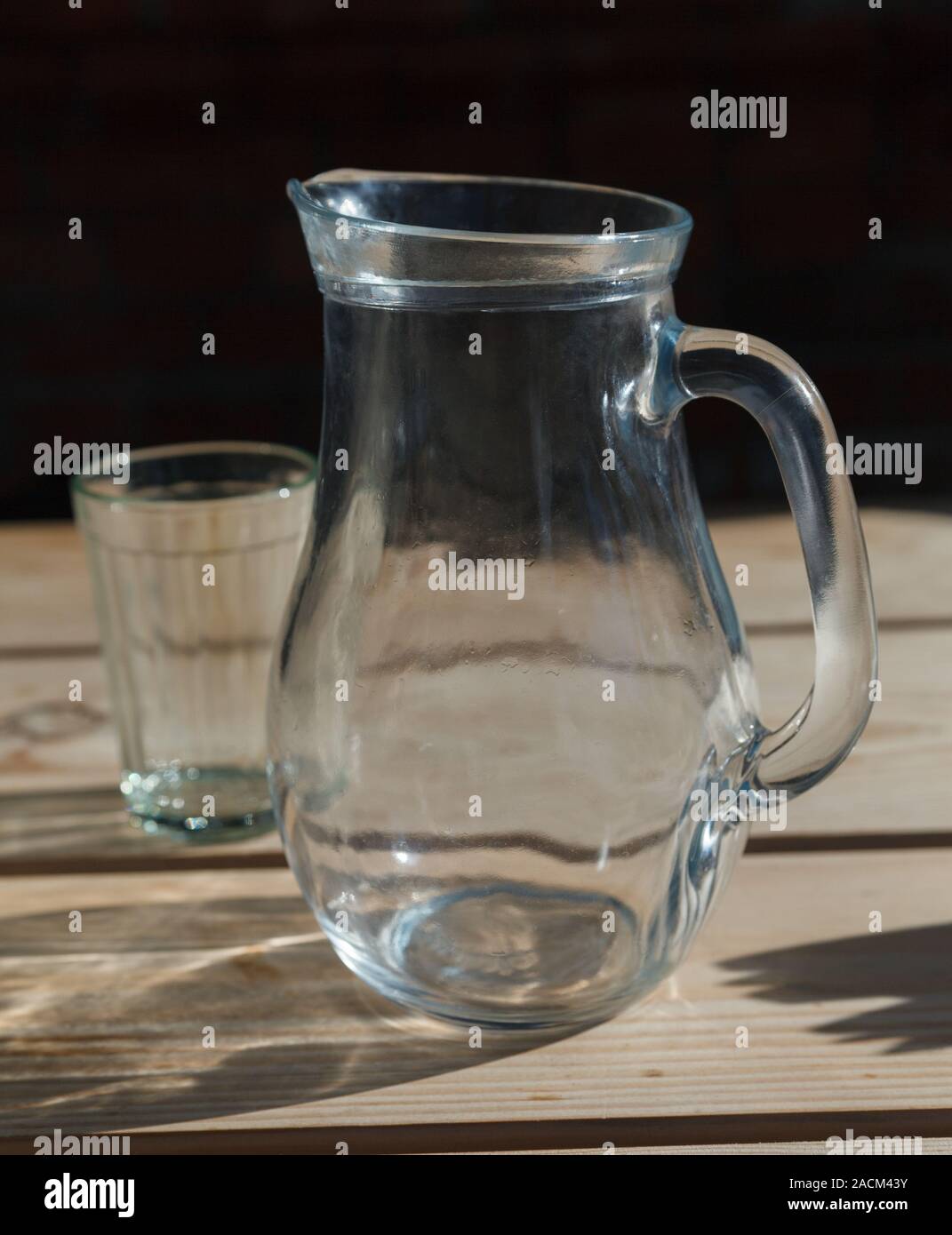 Empty beaker and glass on a natural wooden table Stock Photo - Alamy