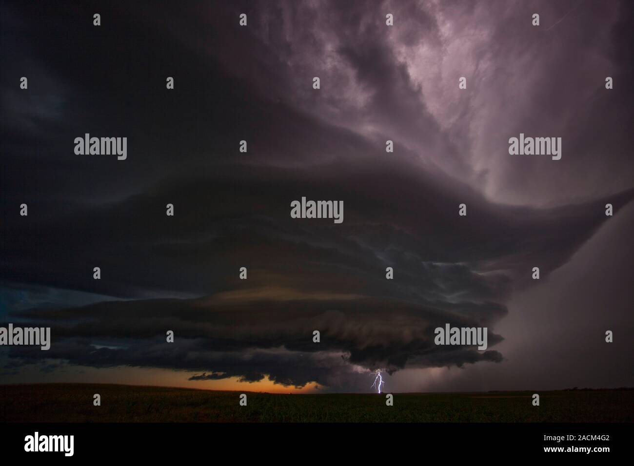 Supercell thunderstorm. Time-exposure image of lightning (lower right ...