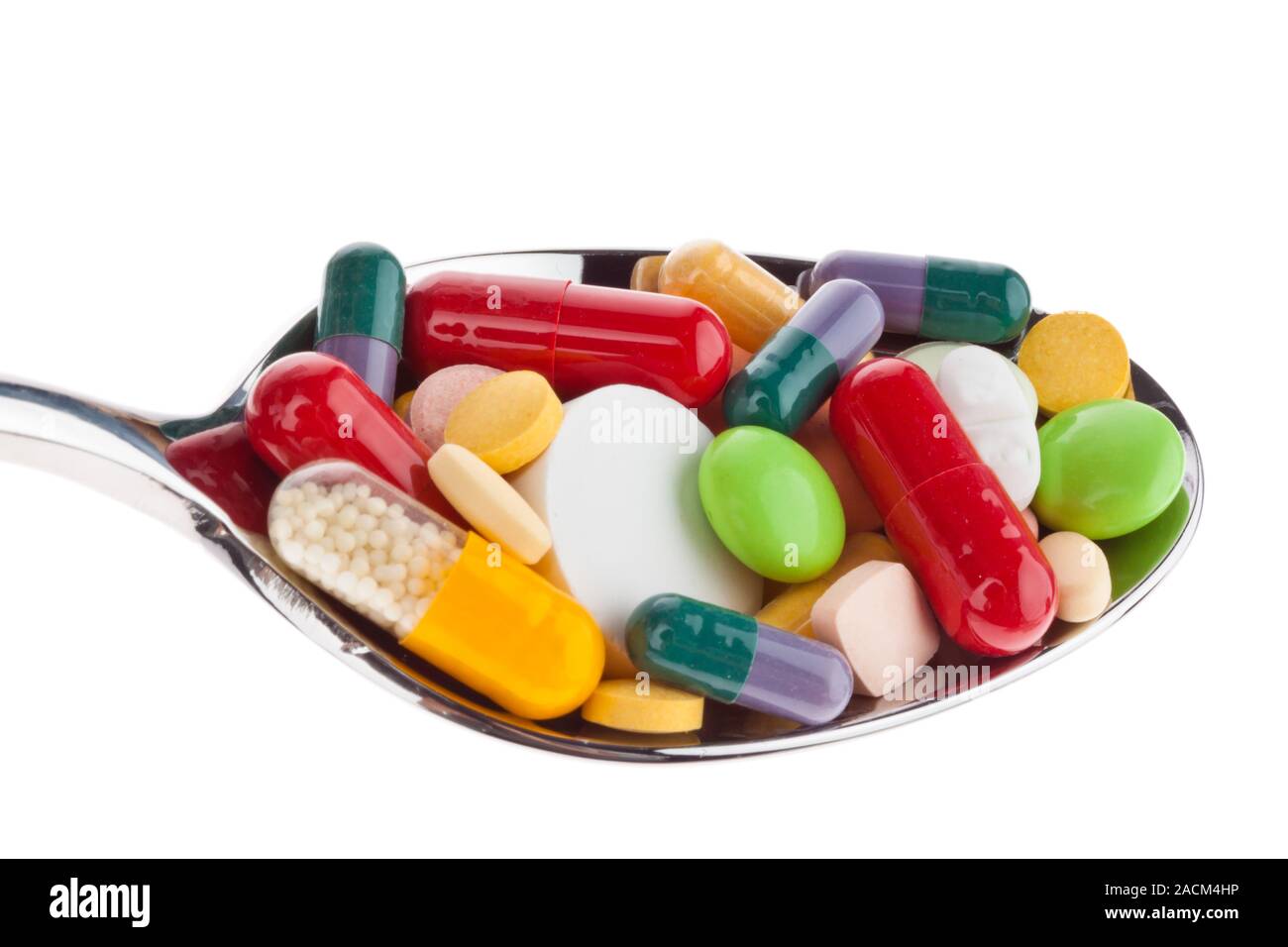 Tablets and medicines on spoons Stock Photo - Alamy