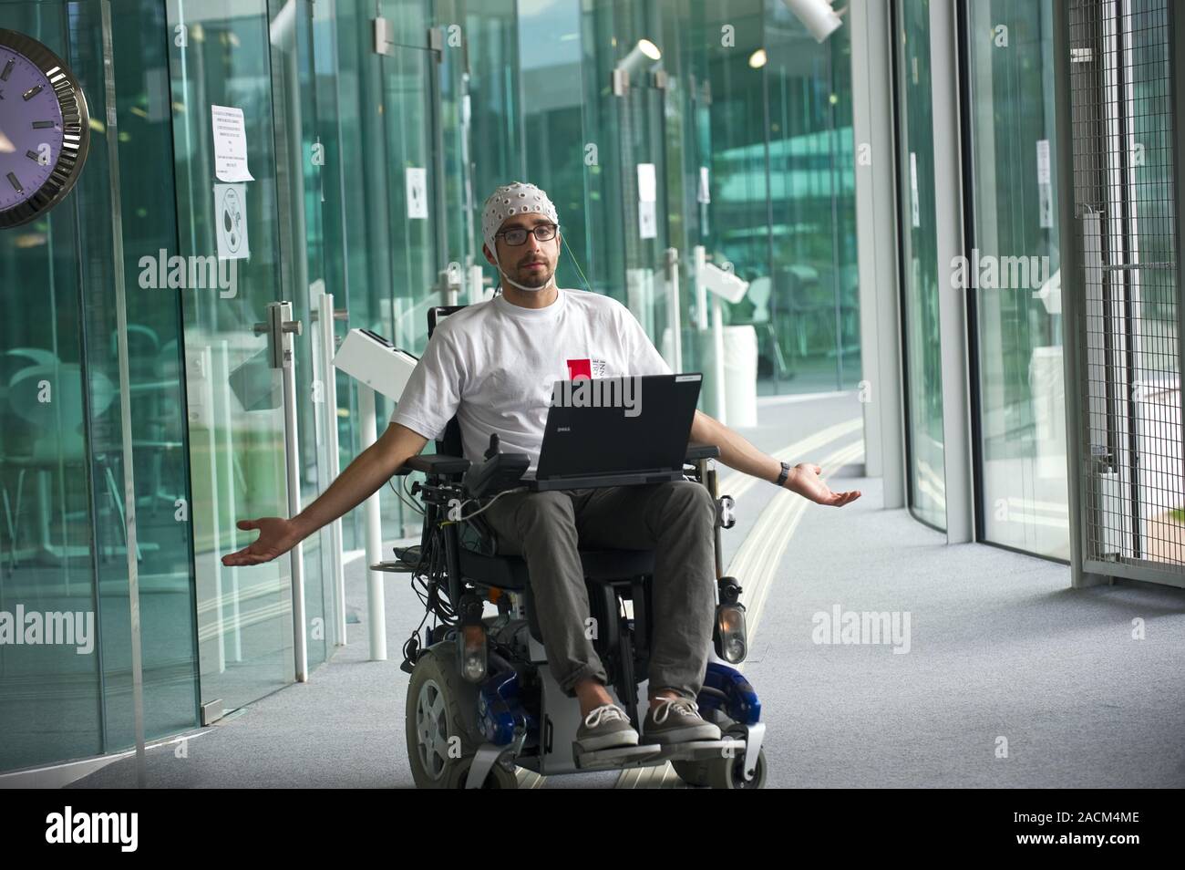 Thought-controlled wheelchair. Researcher testing a brain-machine ...